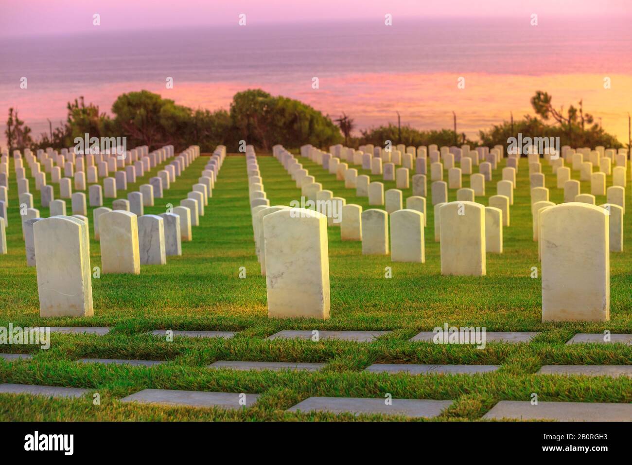 Cemetery graveyard white tombstones at colorful sunset sky. American ...