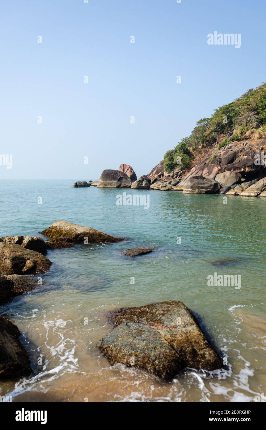 View of the rocky shoreline and clear blue water at Butterfly beach ...