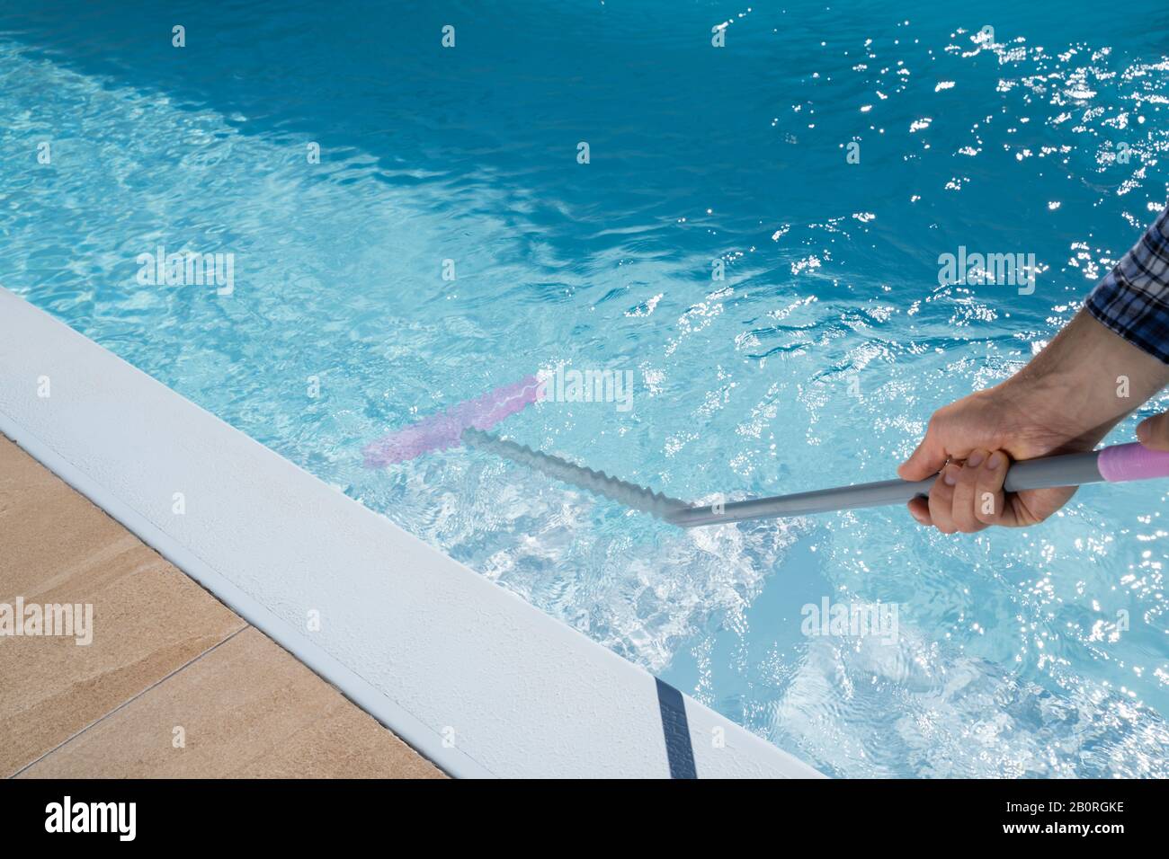 Male Worker In Uniform Cleaning Swimming Pool Stock Photo - Alamy