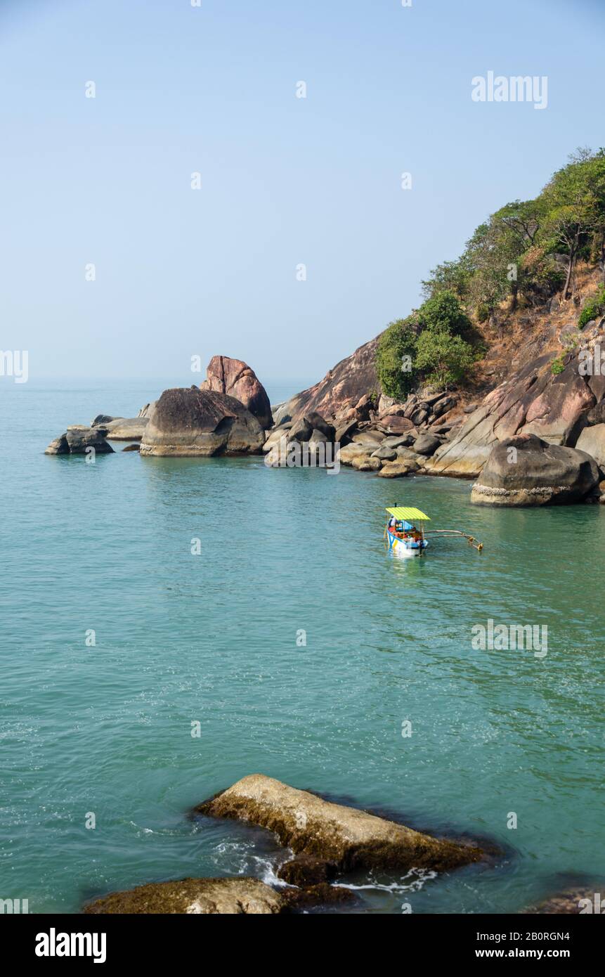 View of the rocky shoreline and clear blue water at Butterfly beach ...