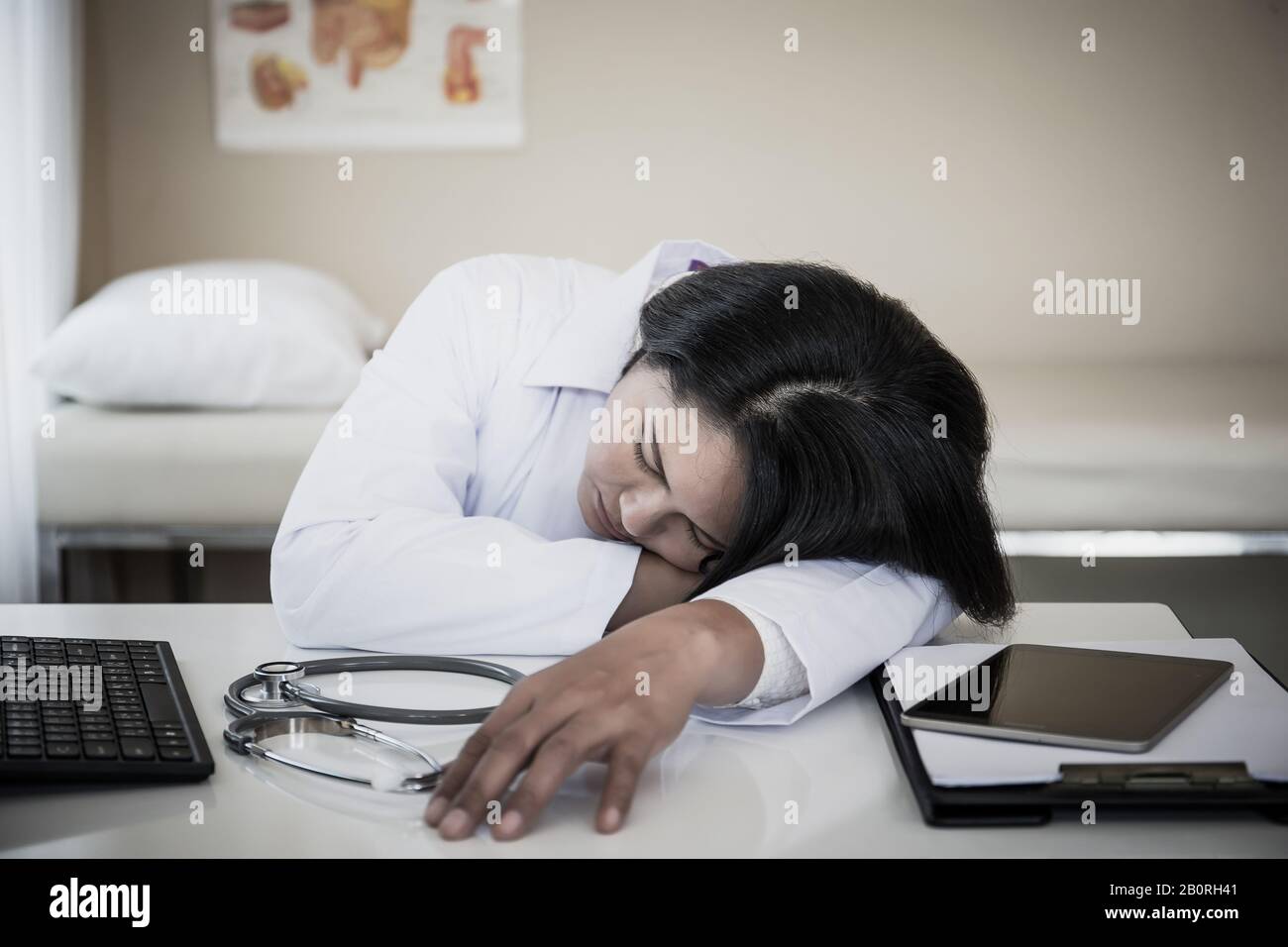 Overworked medical staff sleep on her workplace Stock Photo - Alamy