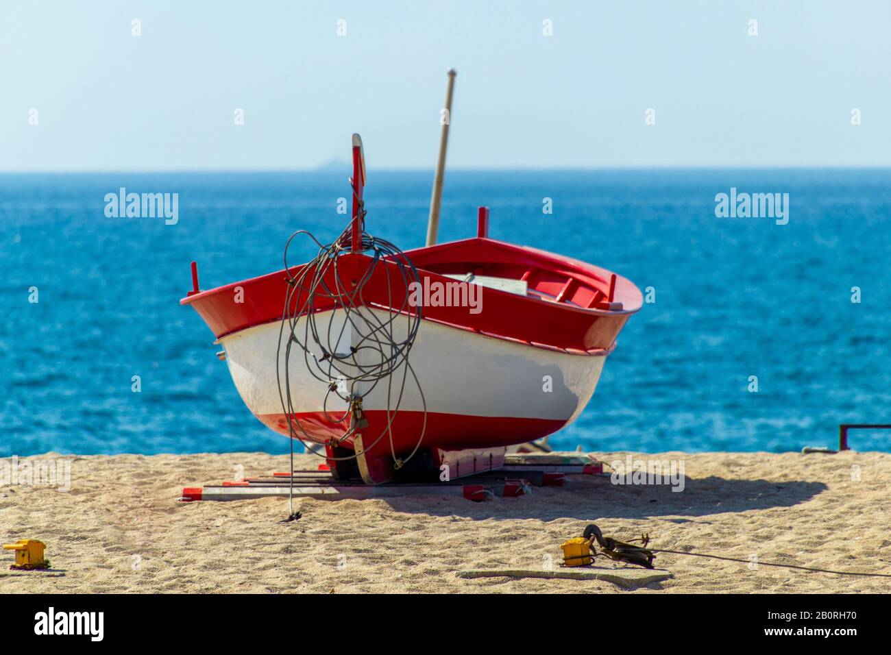 Red rowboat on the sand Stock Photo - Alamy