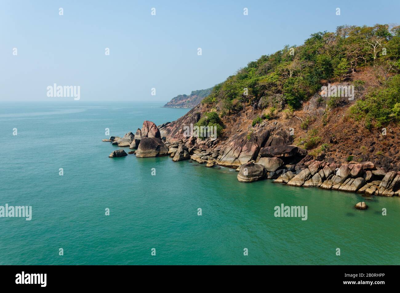 High angle view of the rocky shoreline and clear blue water at ...