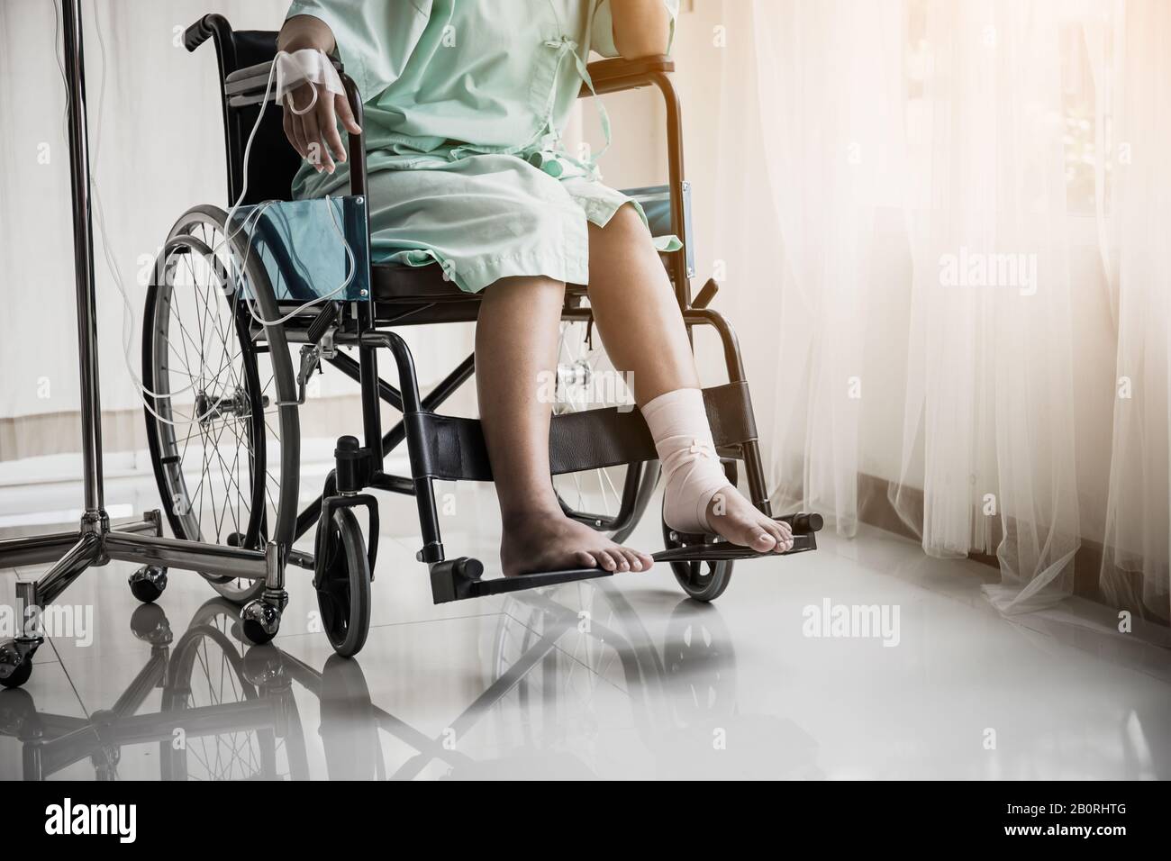 Close up of patient's leg is splinted sitting a wheelchair in the ...