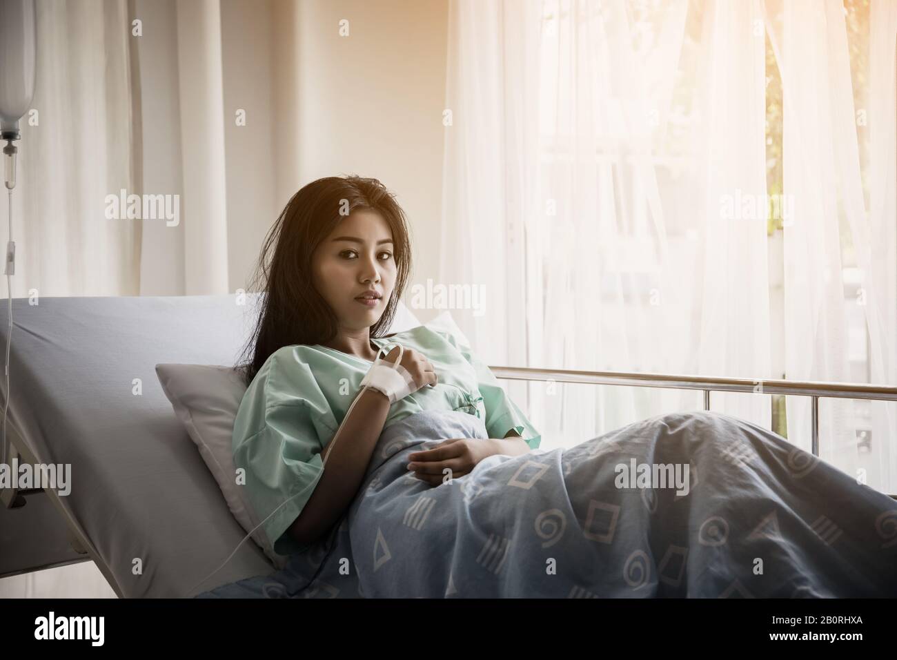Patient woman lying in hospital bed Stock Photo - Alamy