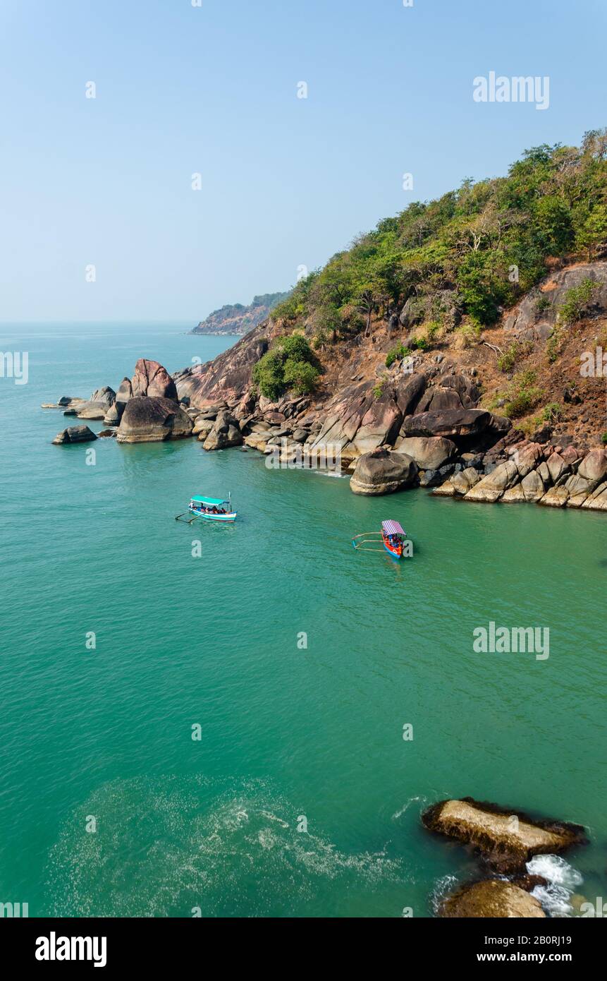 High angle view of the rocky shoreline and clear blue water at ...