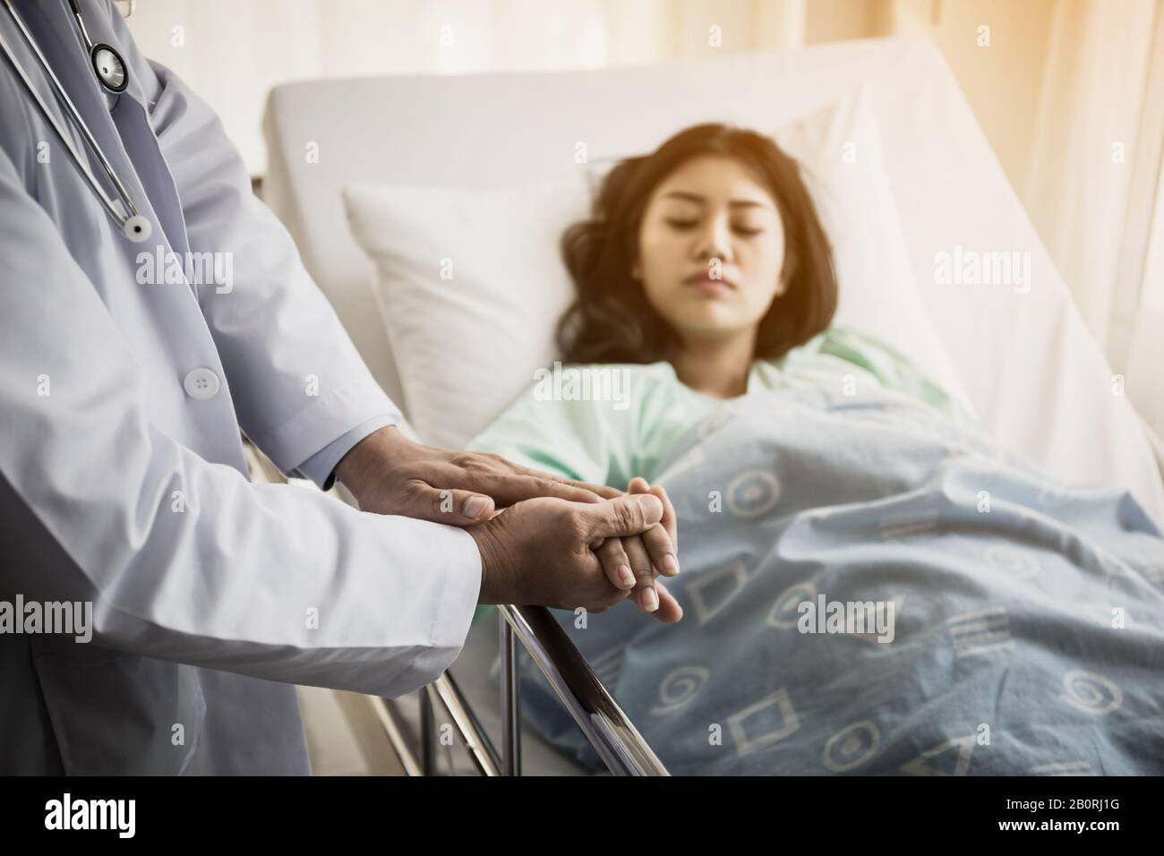 Medical doctor talking to patient and Holding her hand to comforting ...