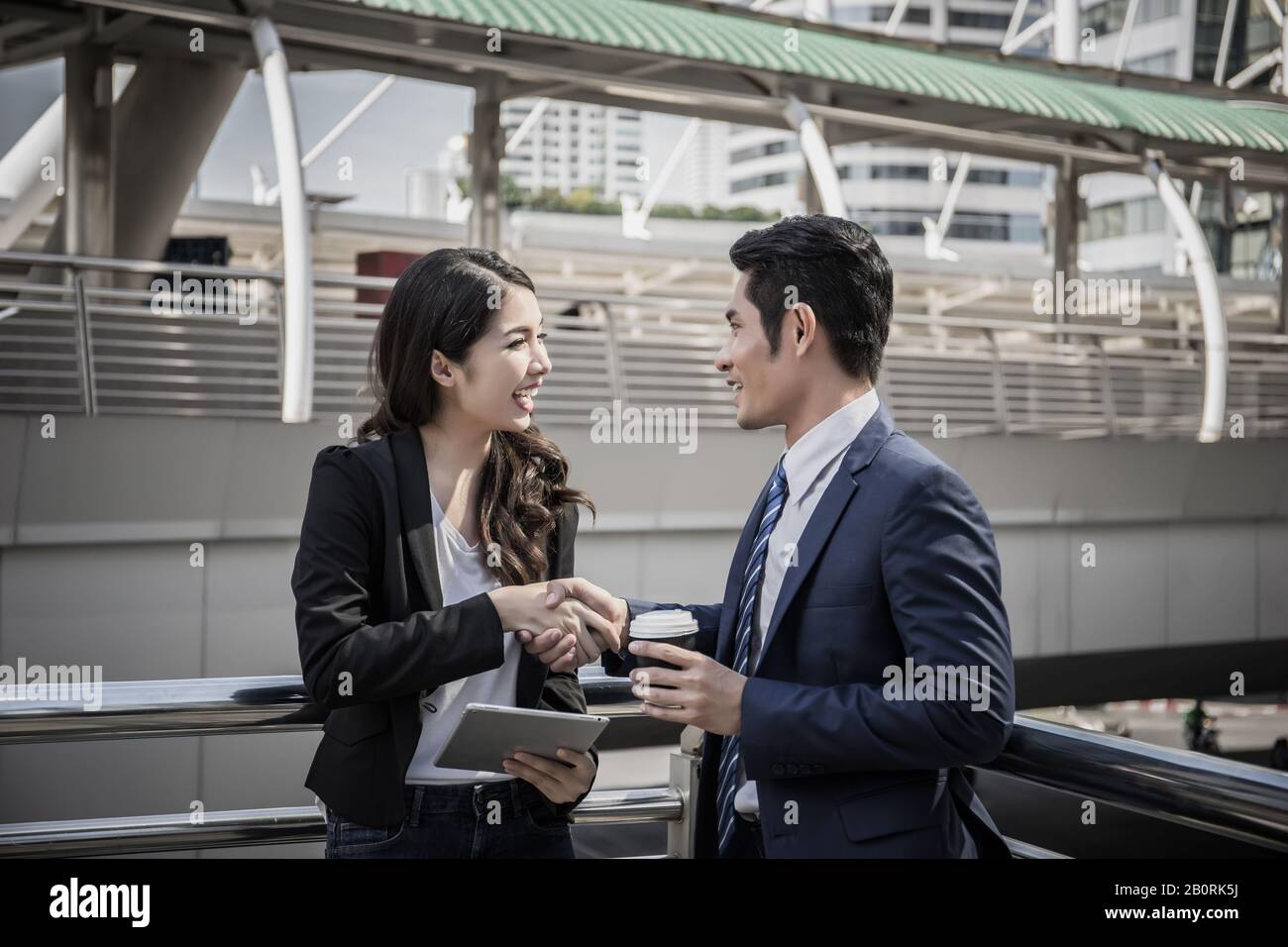 Business partner work hands shaking while looking at successful work at ...