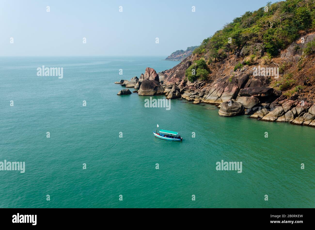 High angle view of the rocky shoreline and clear blue water at ...