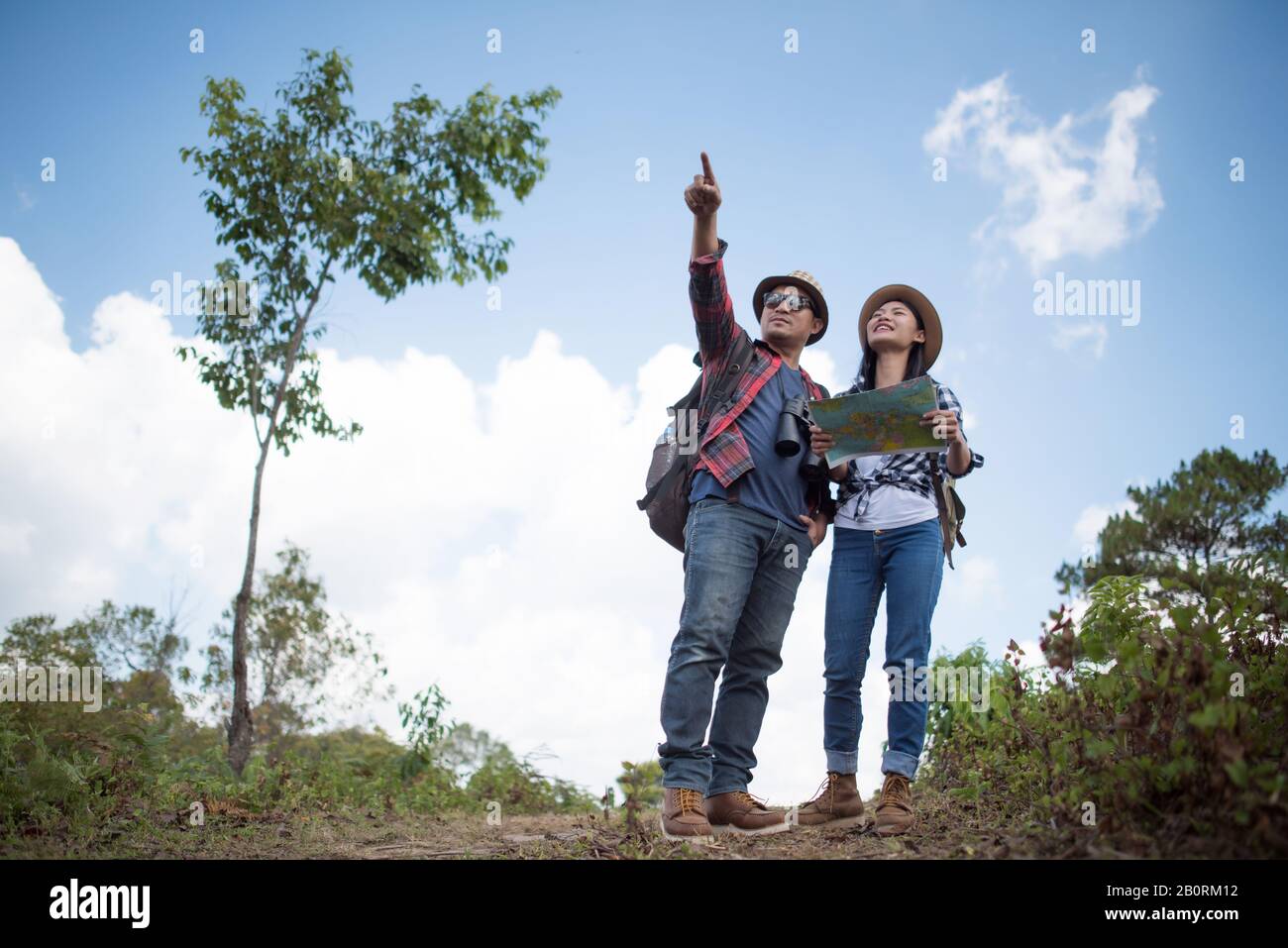 Happy Young hiking standing relax and View map in the forest Stock ...