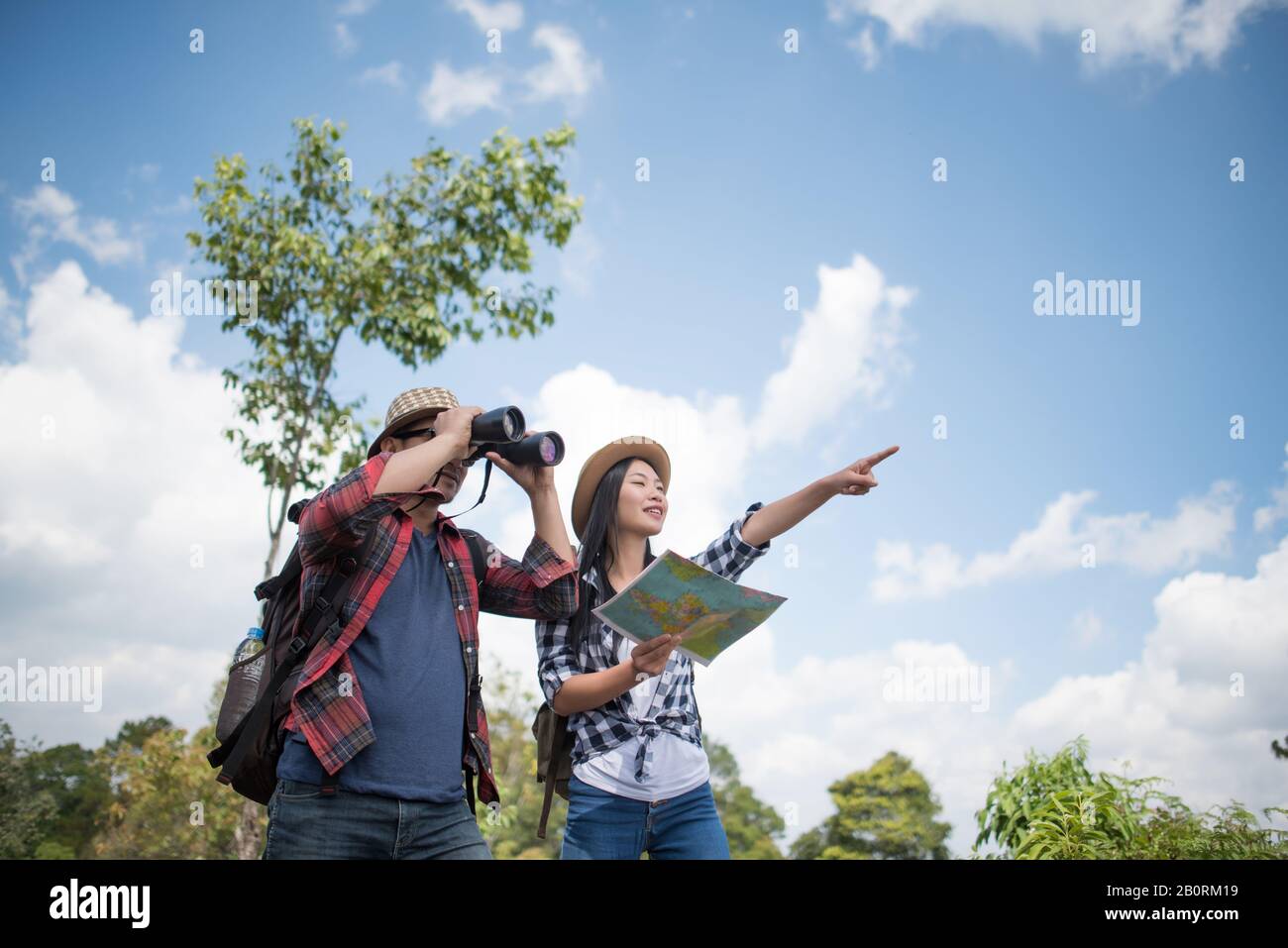 Happy Young hiking standing relax and View map in the forest Stock ...