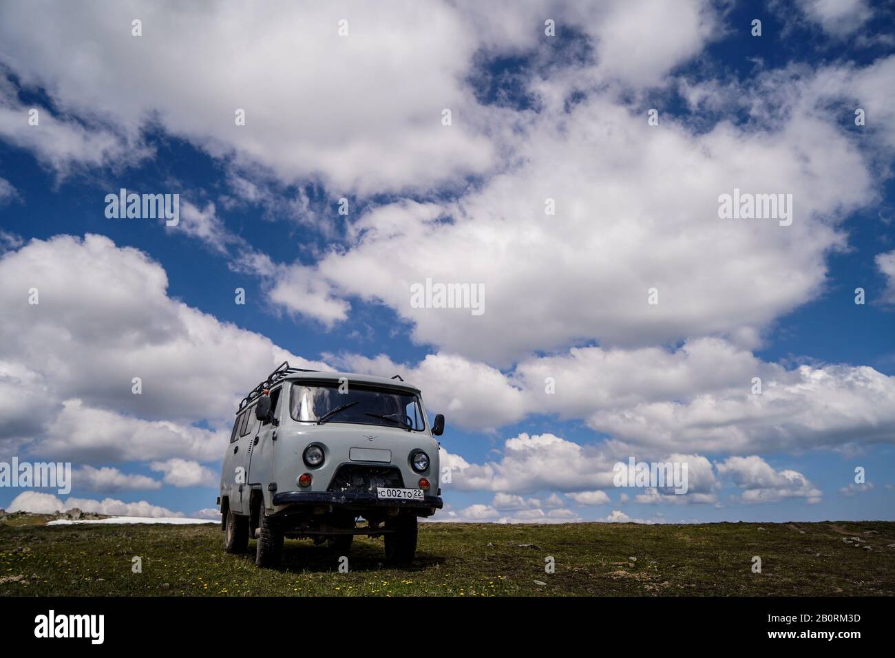 Old russian touristic minibus standing on green grass field with white ...