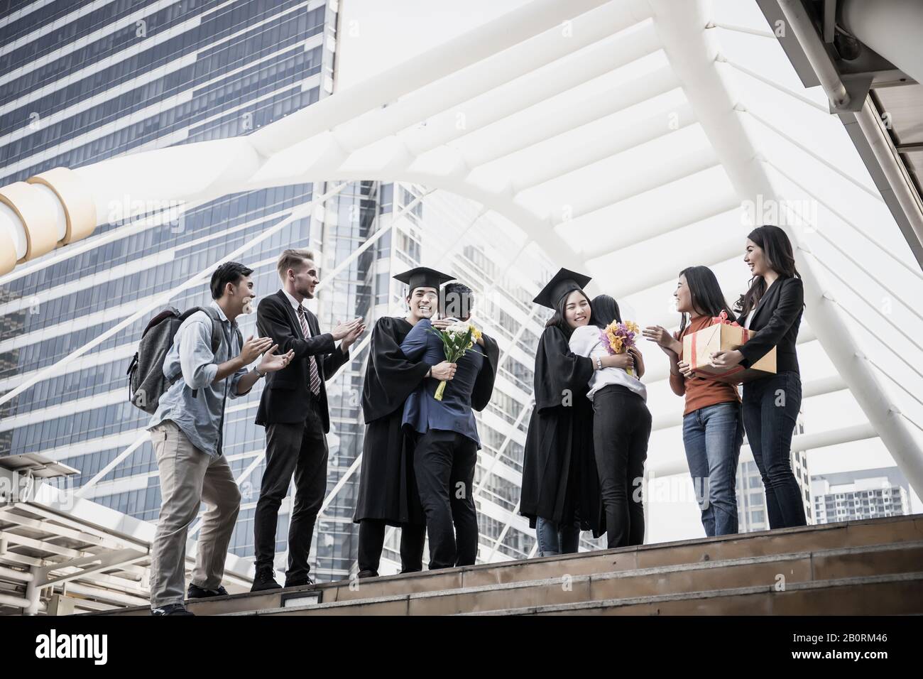 Asian students graduate being congratulated by their parent at ...