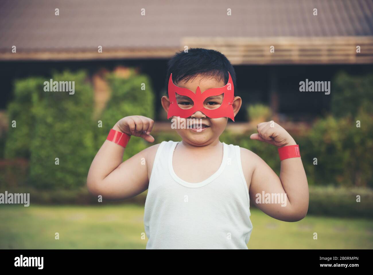 Super boy standing show power strong to fly Stock Photo - Alamy