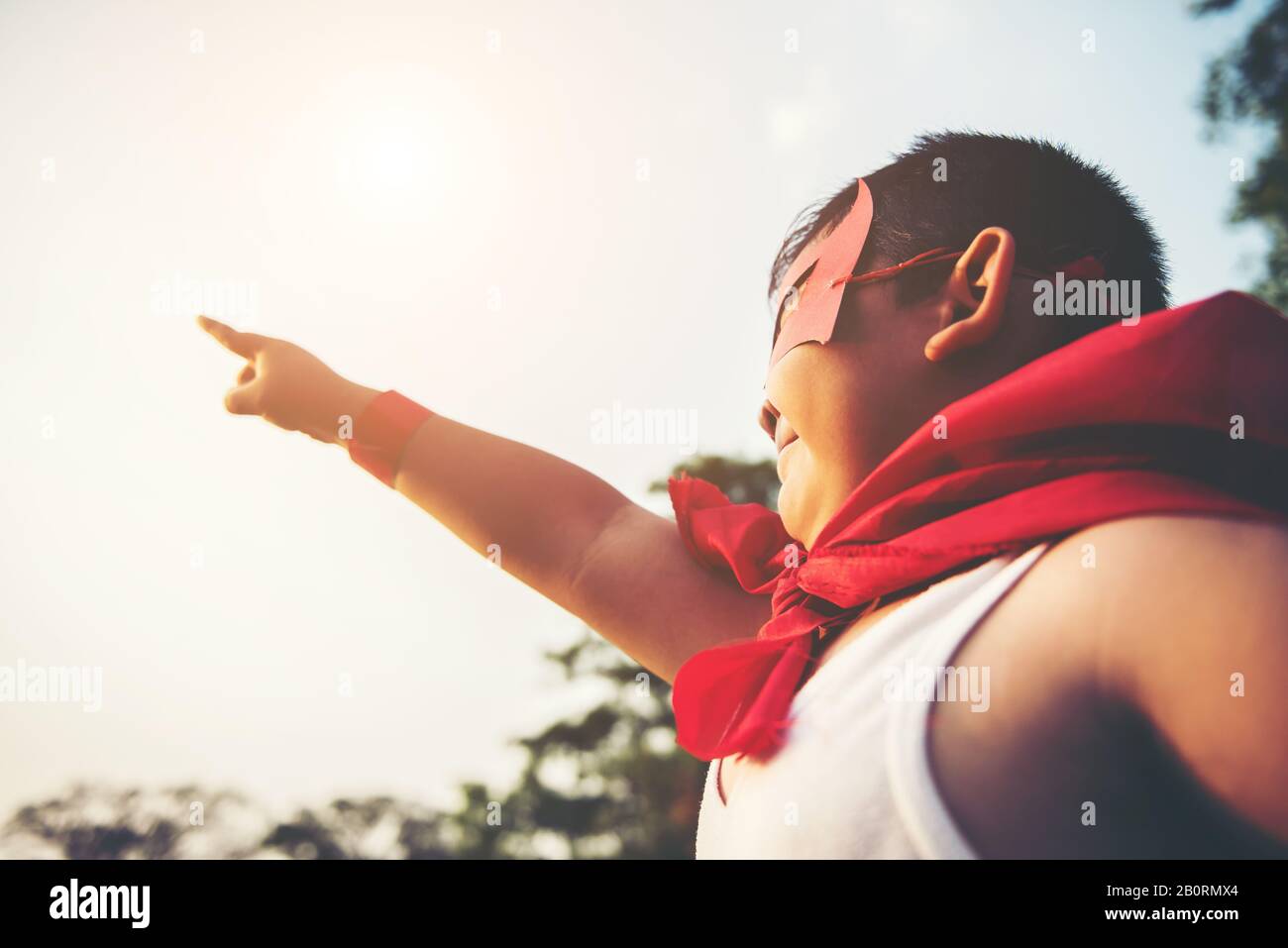 Super boy standing show power strong to fly Stock Photo - Alamy