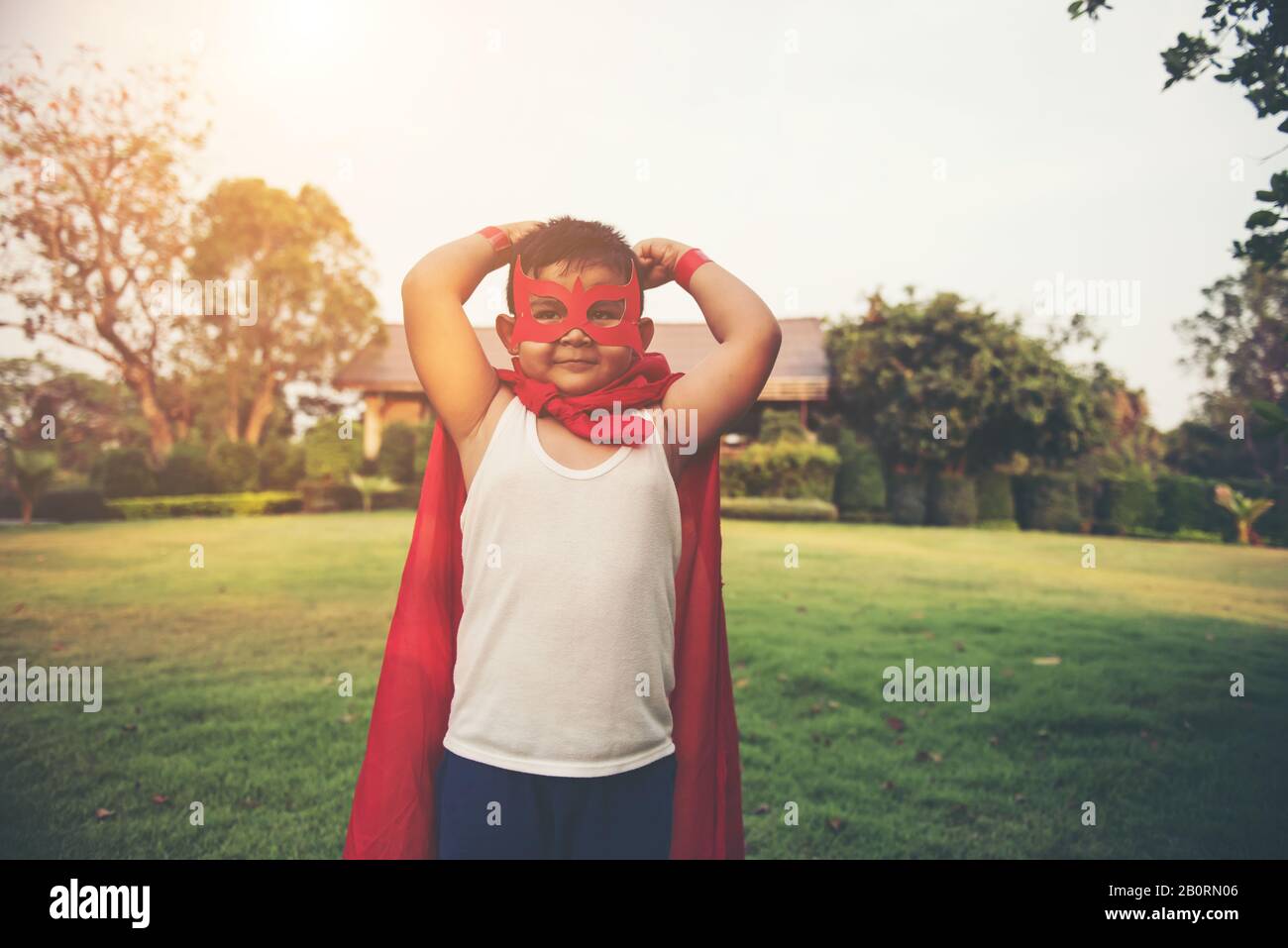 Super boy standing show power strong to fly Stock Photo - Alamy