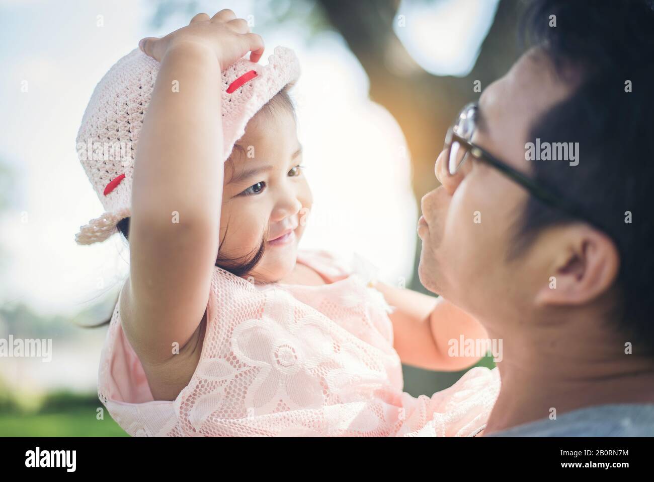 Little girl hugging neck of her daddy, Father playing with daughter ...