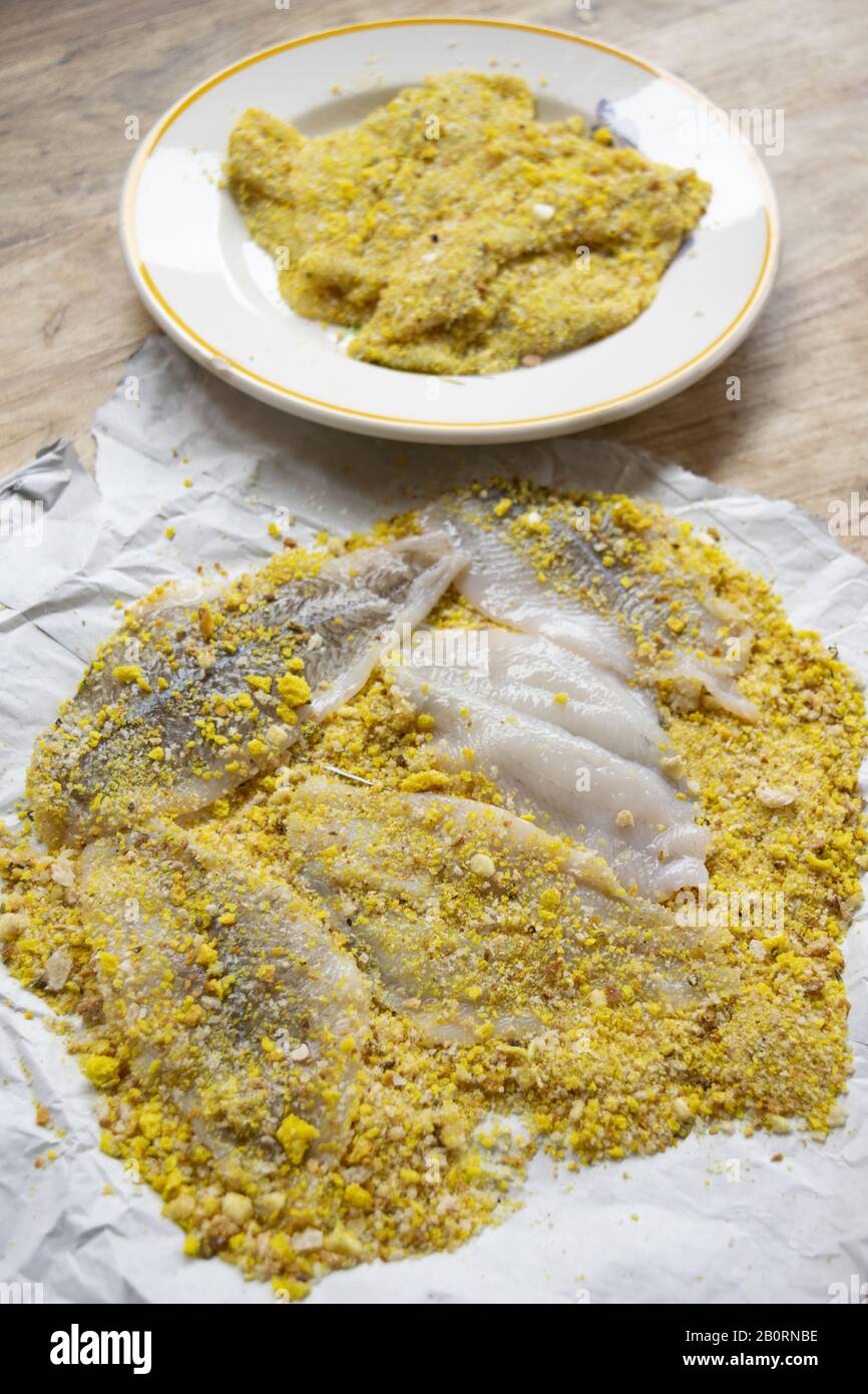 fresh plaice fillets just breaded with crumb and egg Stock Photo - Alamy