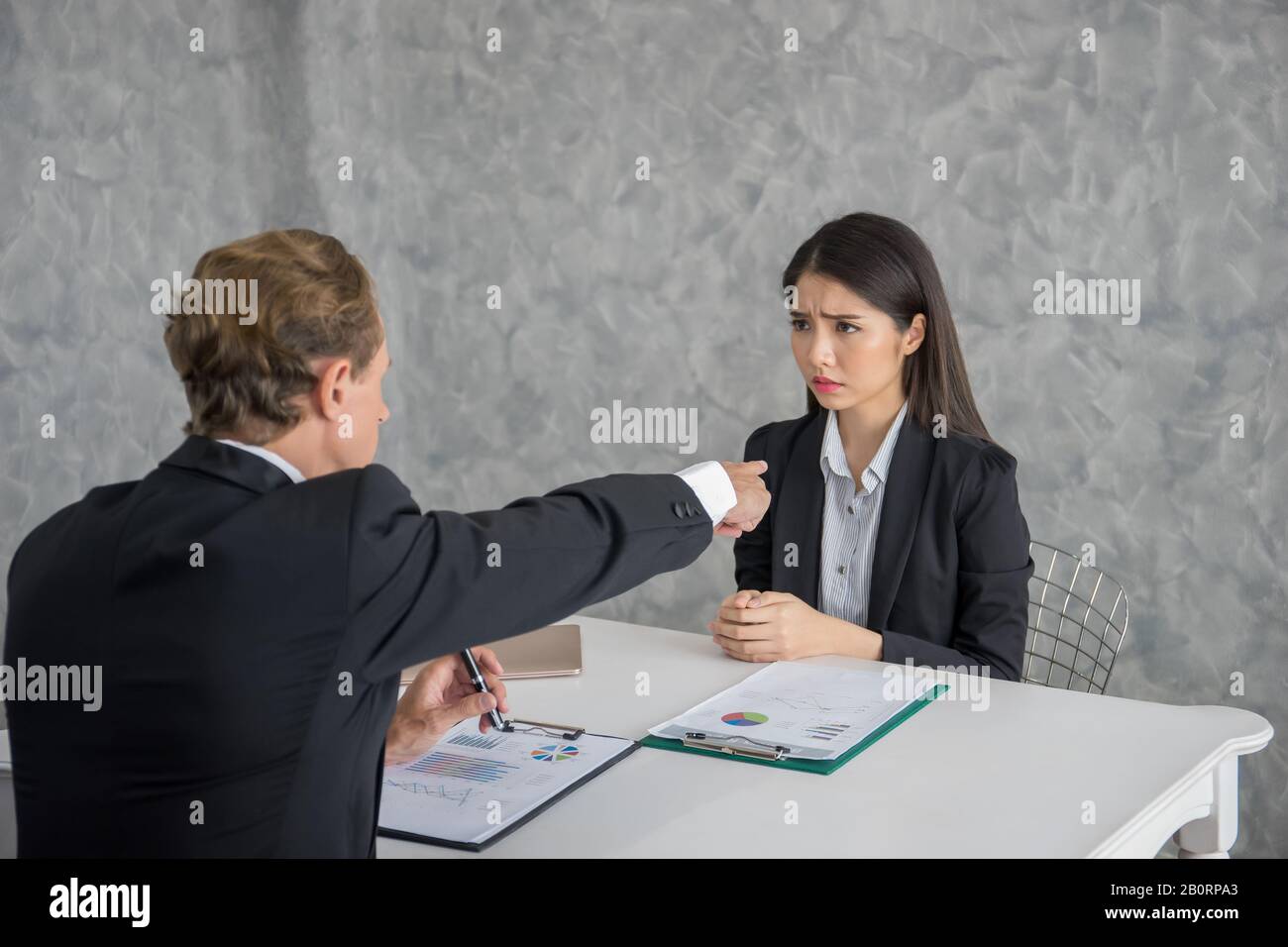Leader businessman blaming female employee at office desk. Fail ...