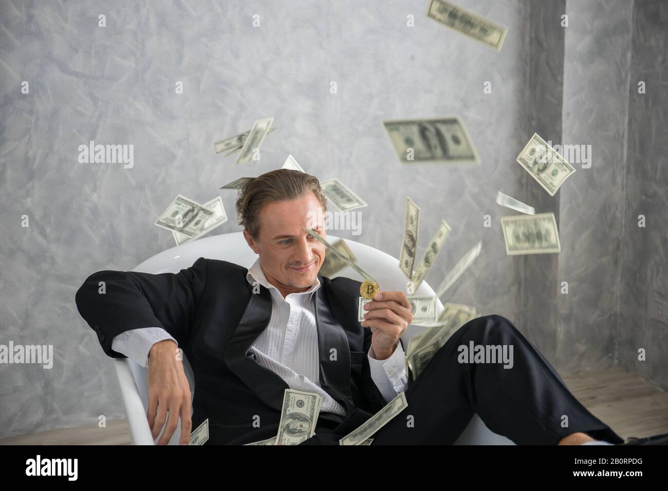 Rich businessman lying in bathtub filled with dollar banknotes. Success ...