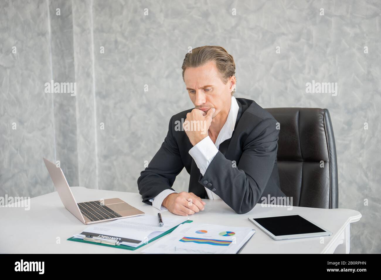 Serious businessman stressed out at work in office. fail business ...