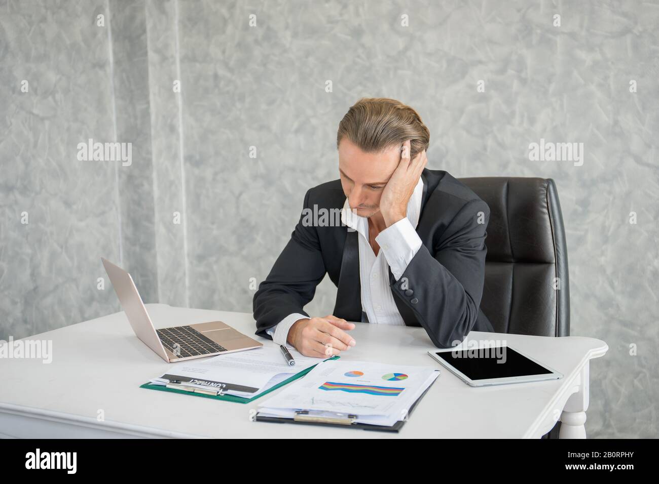 Serious businessman stressed out at work in office. fail business ...
