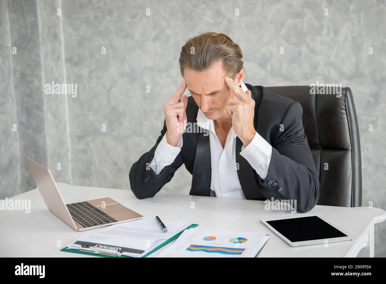 Serious businessman stressed out at work in office. fail business ...