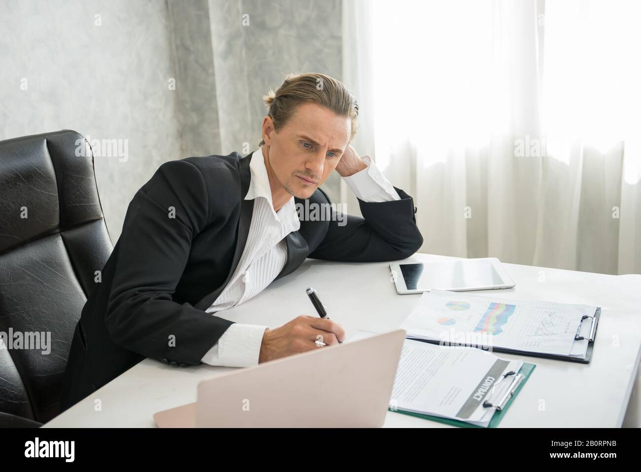 Serious businessman stressed out at work in office. fail business ...