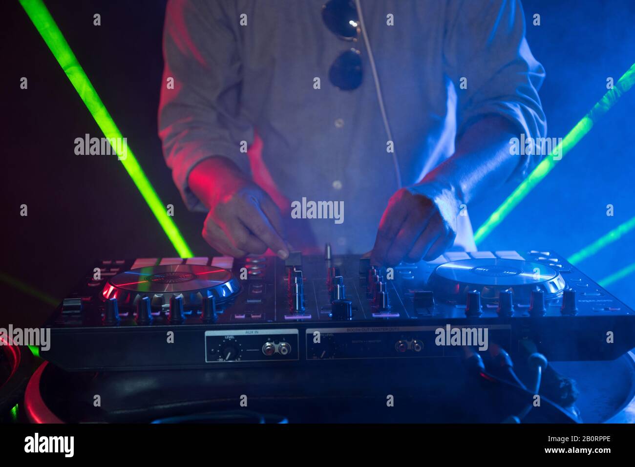 DJ playing turntable music on night club party Stock Photo - Alamy