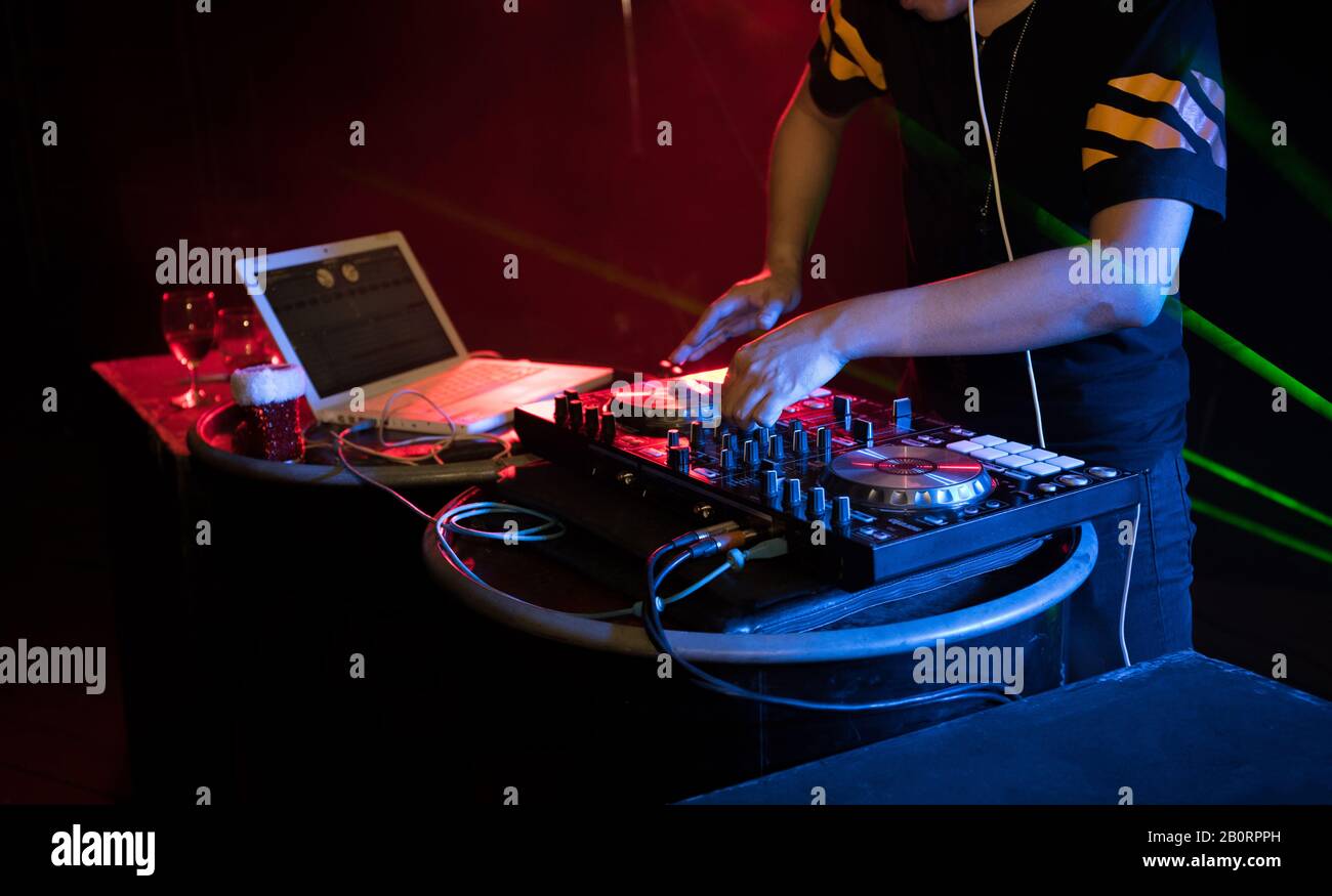 DJ playing turntable music on night club party Stock Photo - Alamy