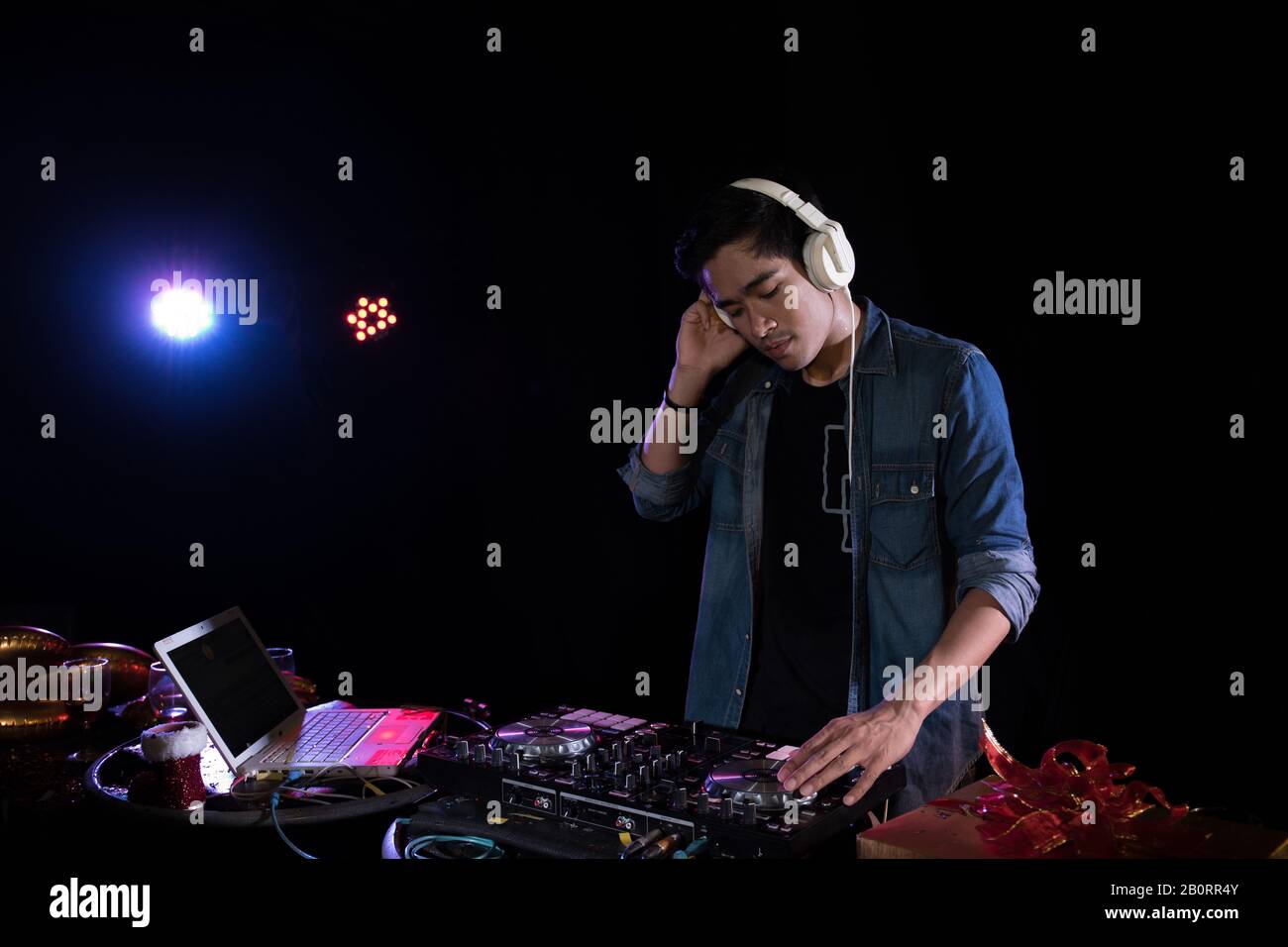 DJ playing turntable music on night club party Stock Photo - Alamy