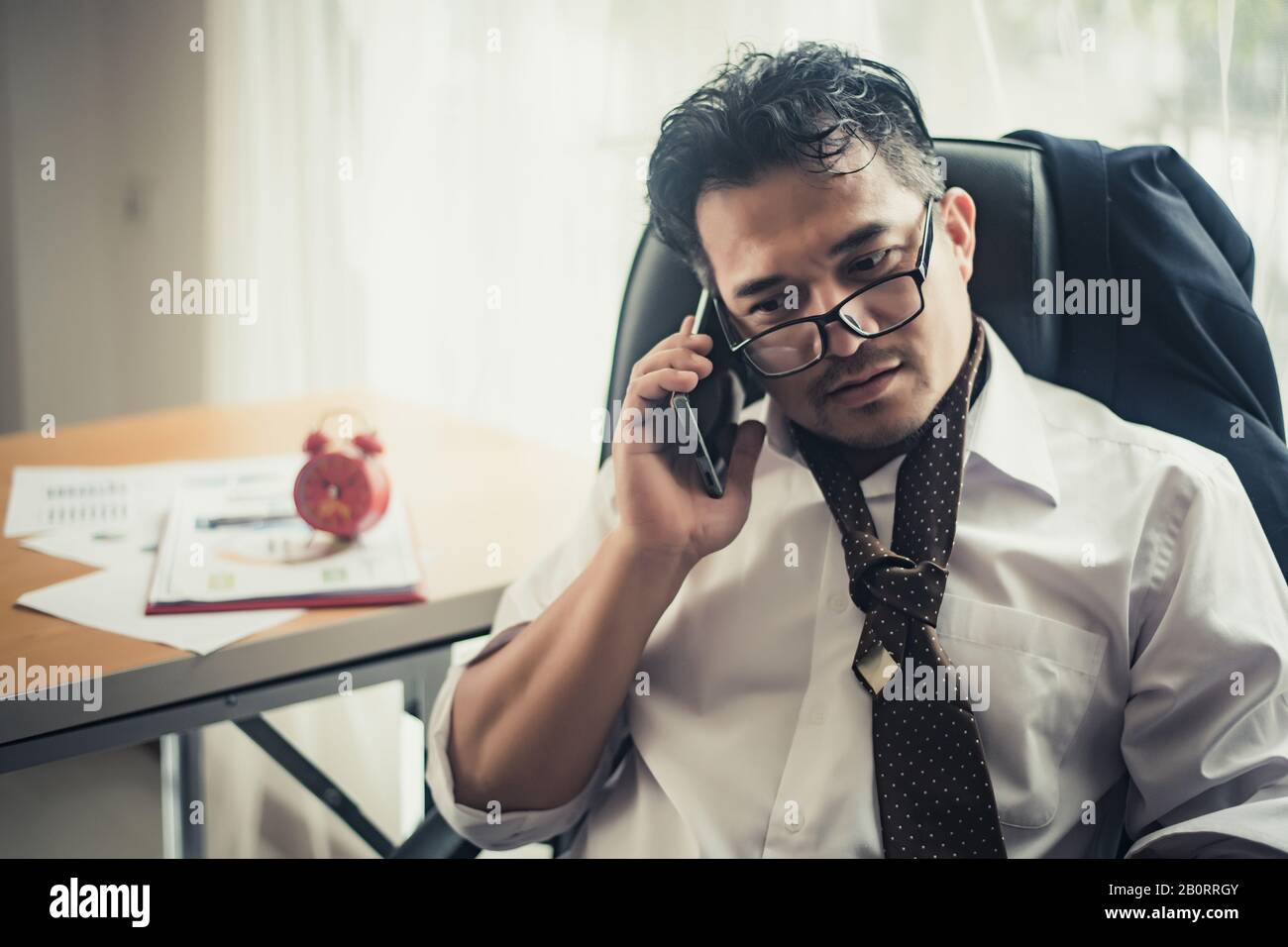 Worried business man at workplace in office after tired from hard work ...