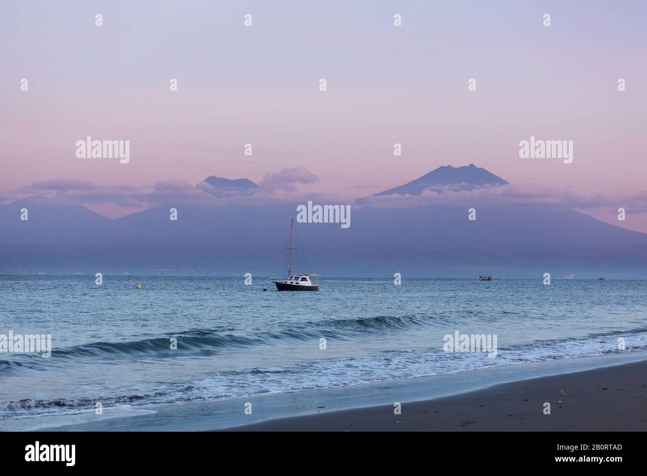 Volcanic beach with rocky mountains in Bali, Indonesia Stock Photo - Alamy