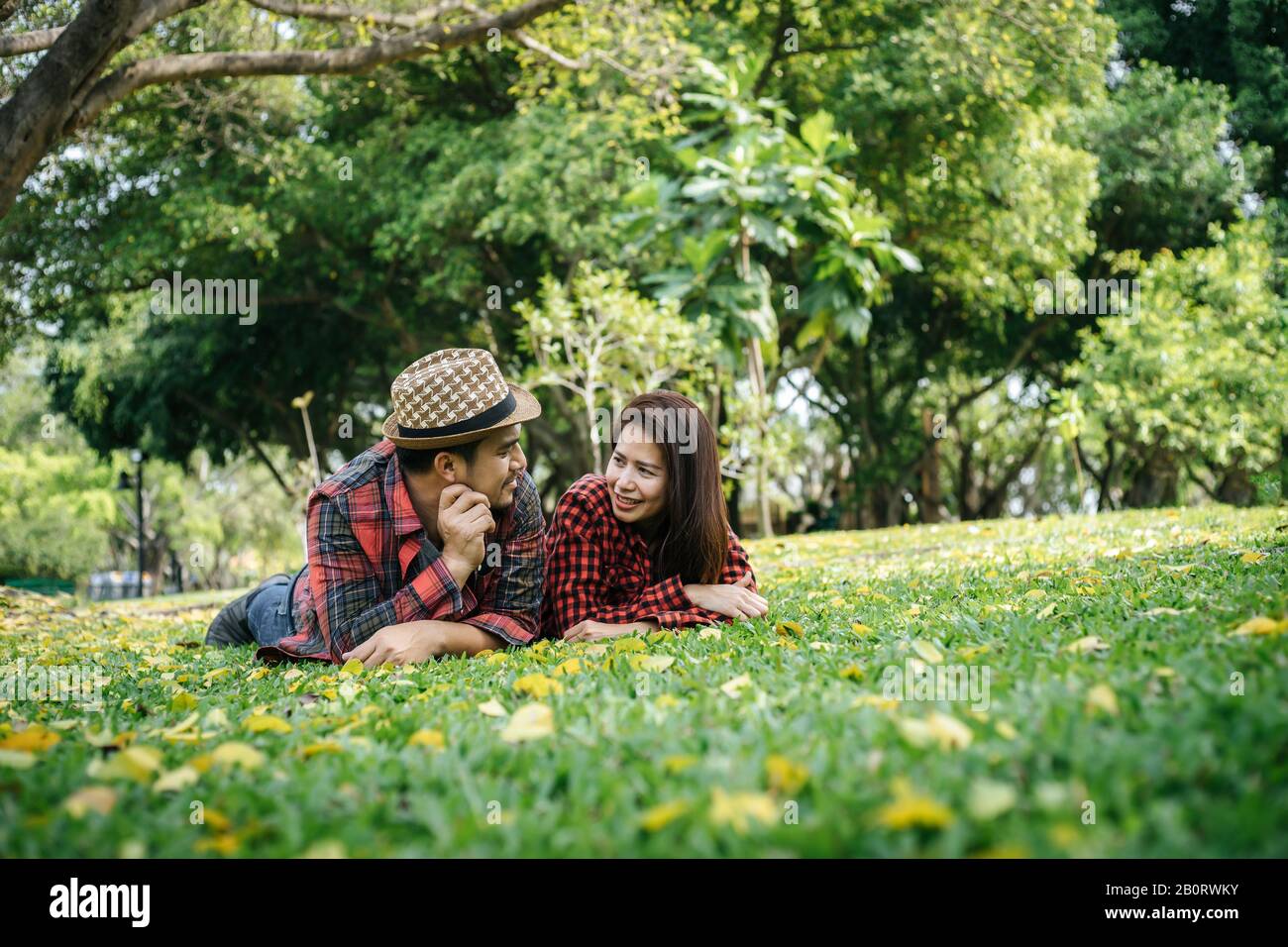 Romantic Young Couple Sitting In Garden Stock Photo - Alamy