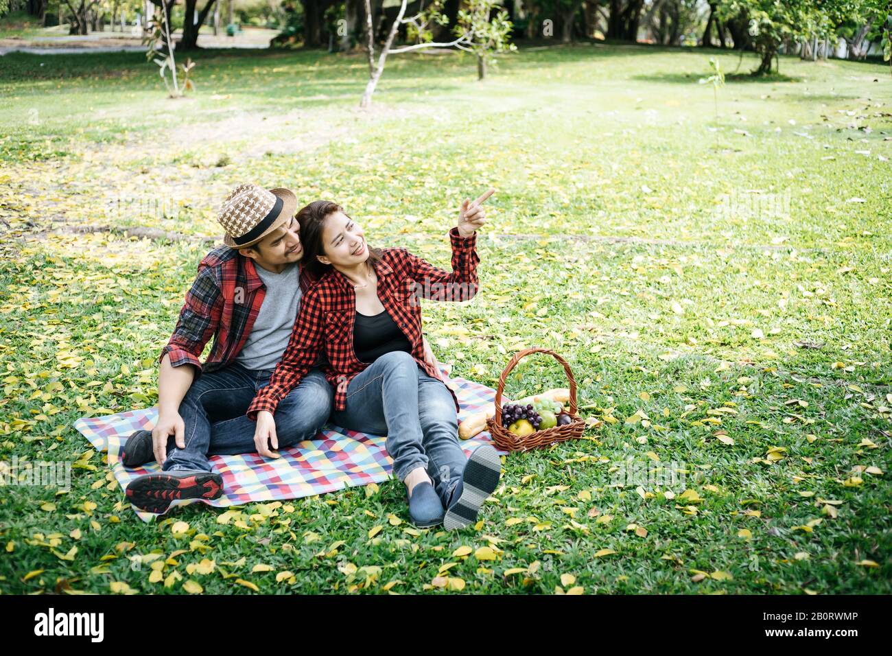 Romantic Young Couple Sitting In Garden Stock Photo - Alamy