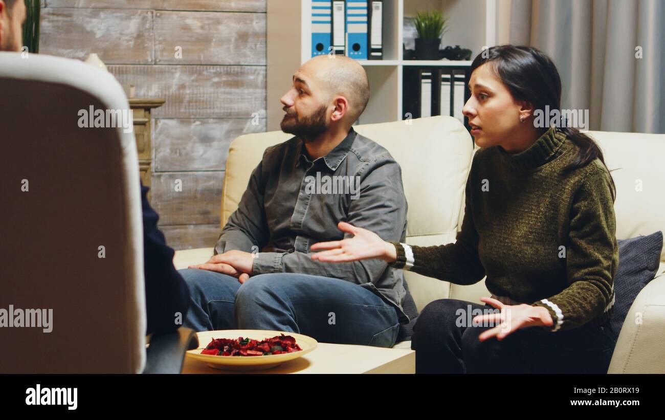 Zoom in shot of angry young wife at couples therapy. Psychologist in ...