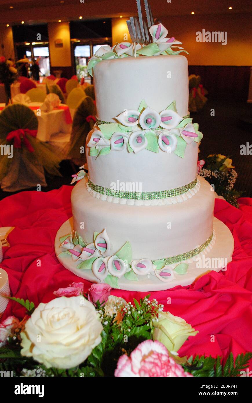 Three-layer white wedding cake with anthurium designed flower ...