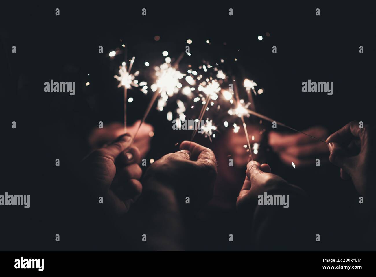 Group of happy people holding sparklers at party and smiling Stock ...