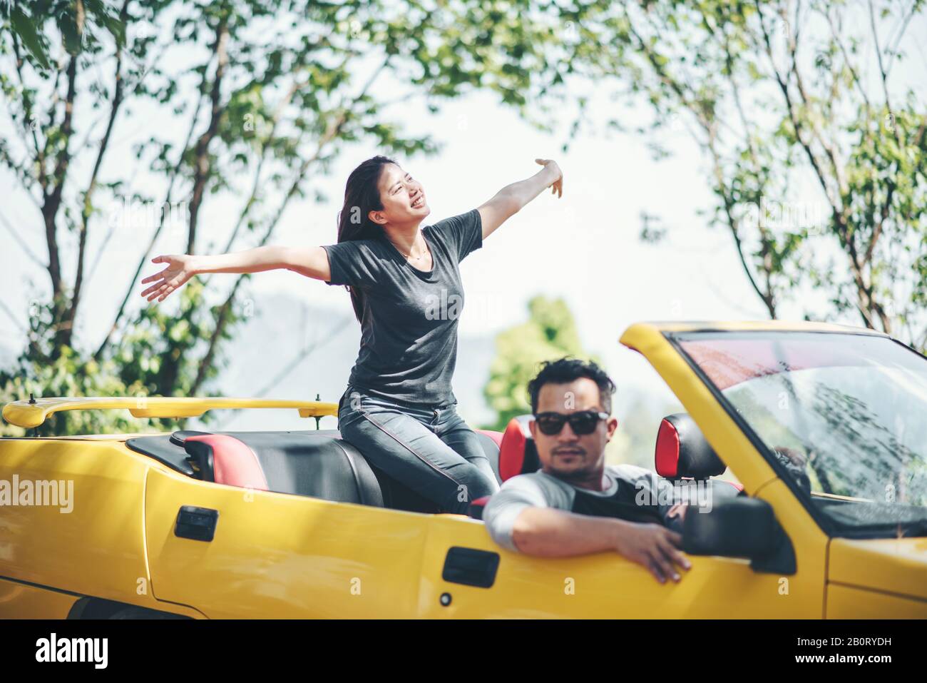 Happy Couple Driving in Convertible Stock Photo - Alamy