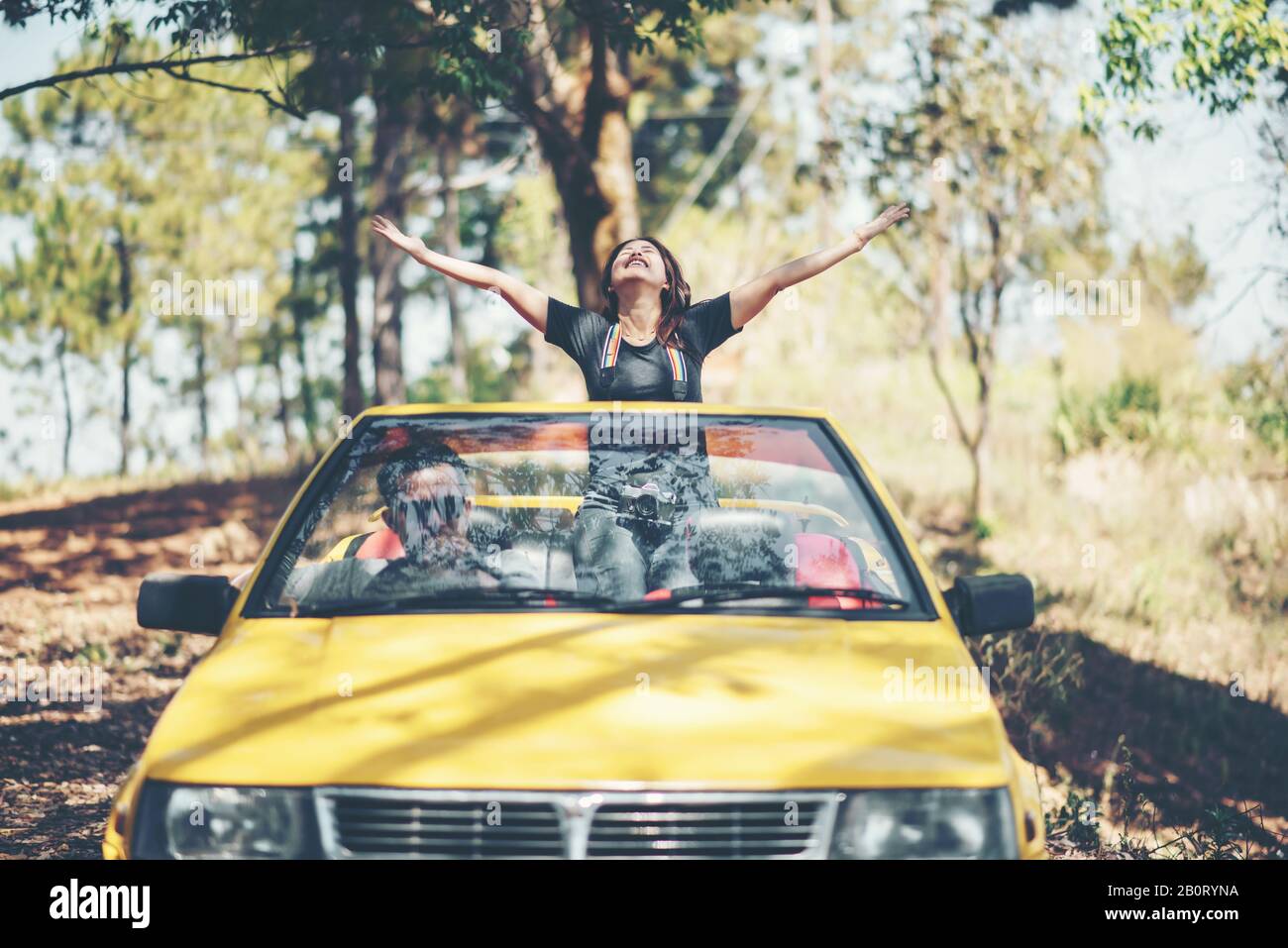 Happy Couple Driving in Convertible Stock Photo - Alamy