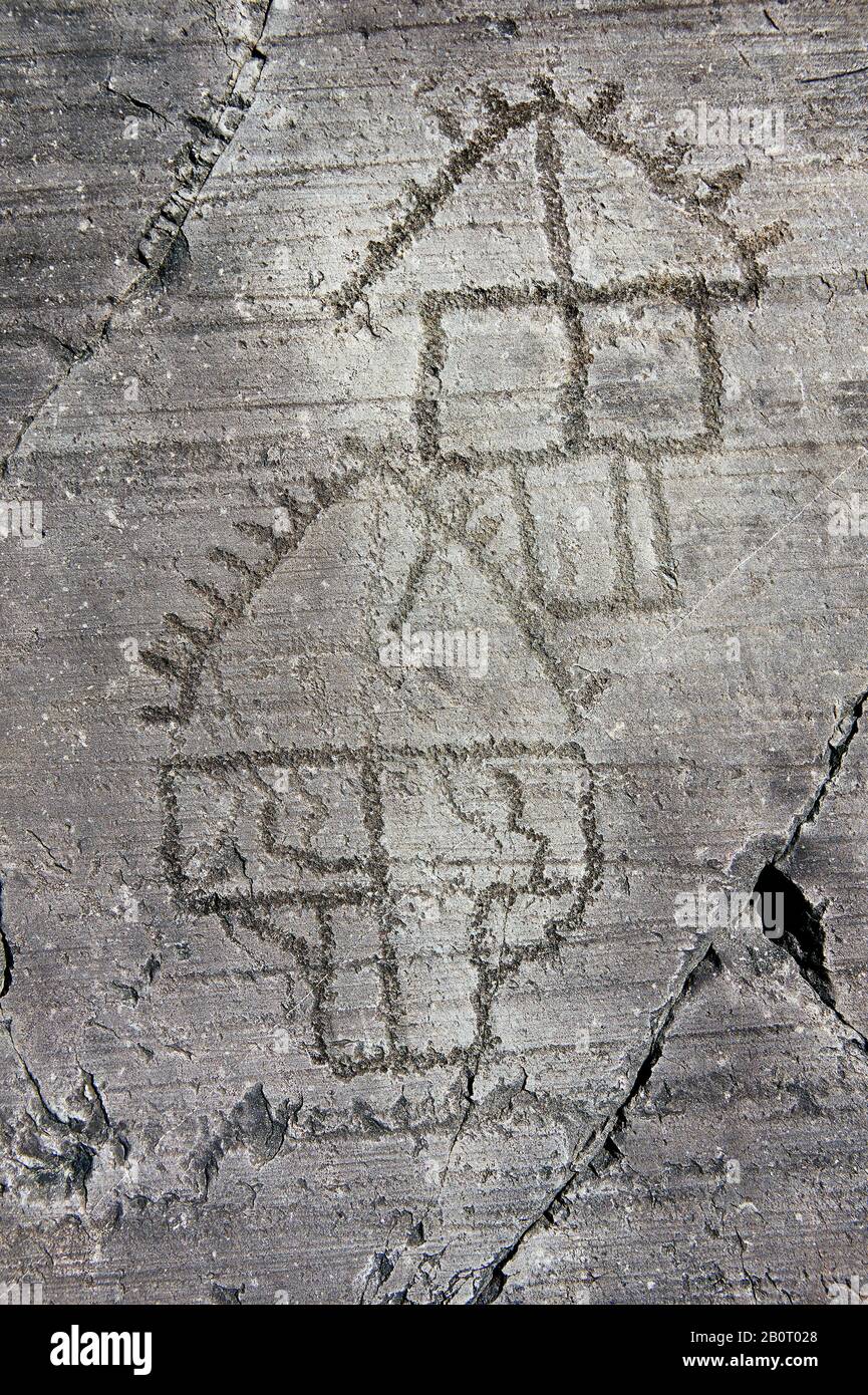 Petroglyph, rock carving, of two houses on stilts. Carved by the ...