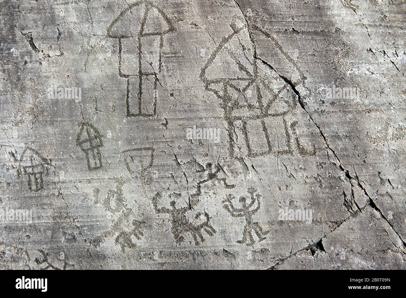 Petroglyph, rock carving, of a village with houses on stilts and a ...