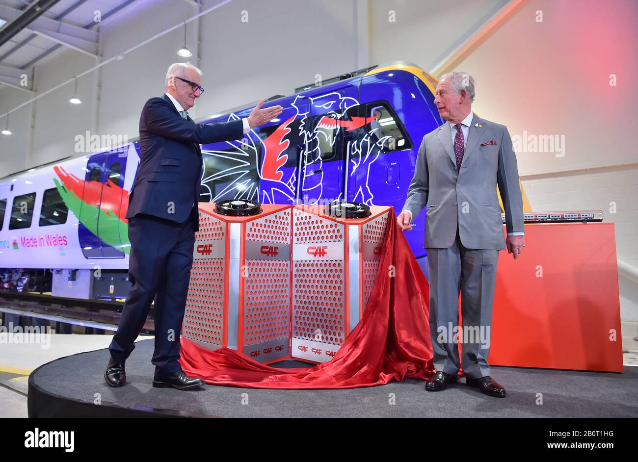 The Prince of Wales (right) unveils a plaque with chief executive ...
