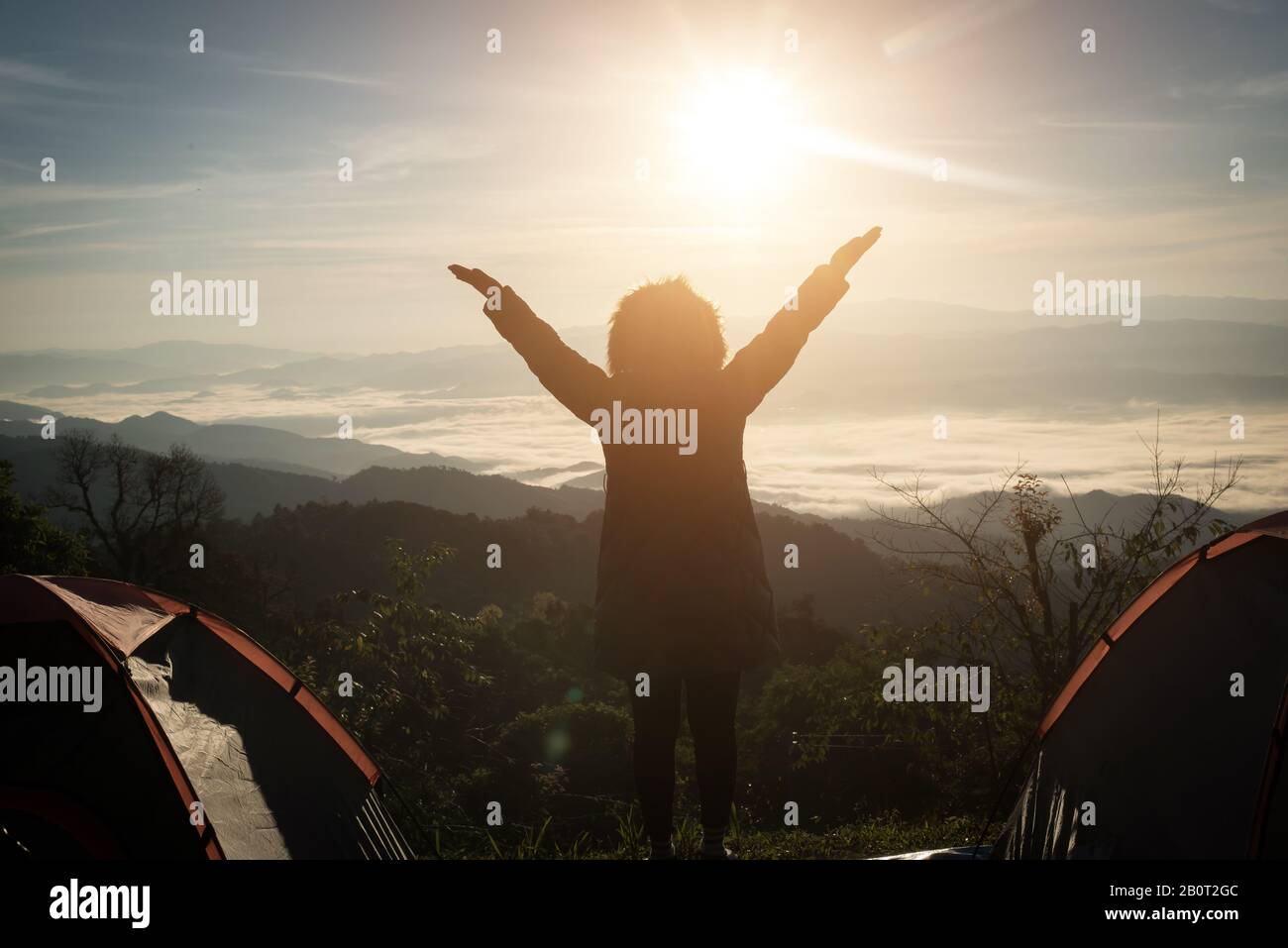 Happy Young Woman Hiker With Open Arms Raised at Sunset on Mountain ...