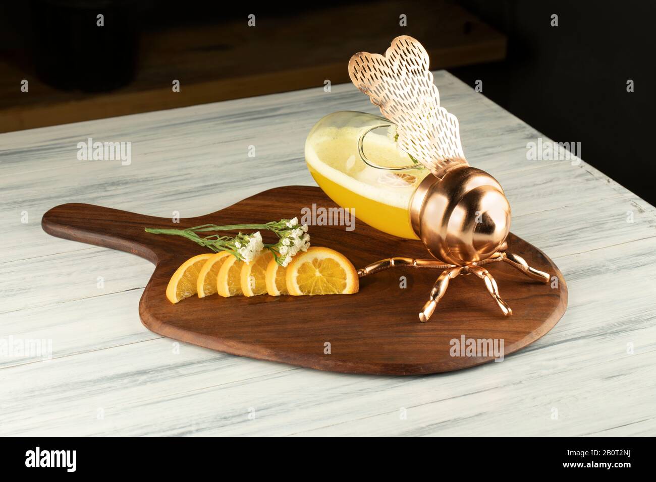 Artisan orange mocktail served in fancy bee container Stock Photo - Alamy