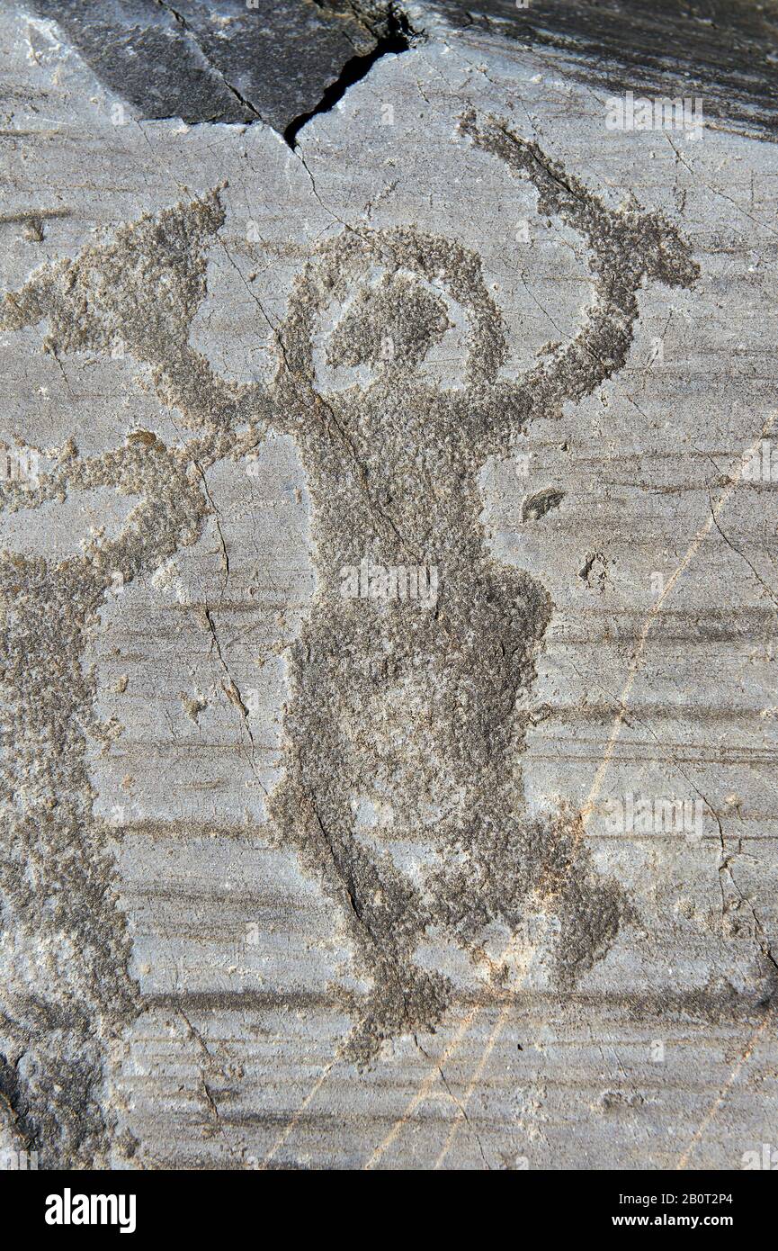 Petroglyph, rock carving, of a warriors with a helmet, small round ...