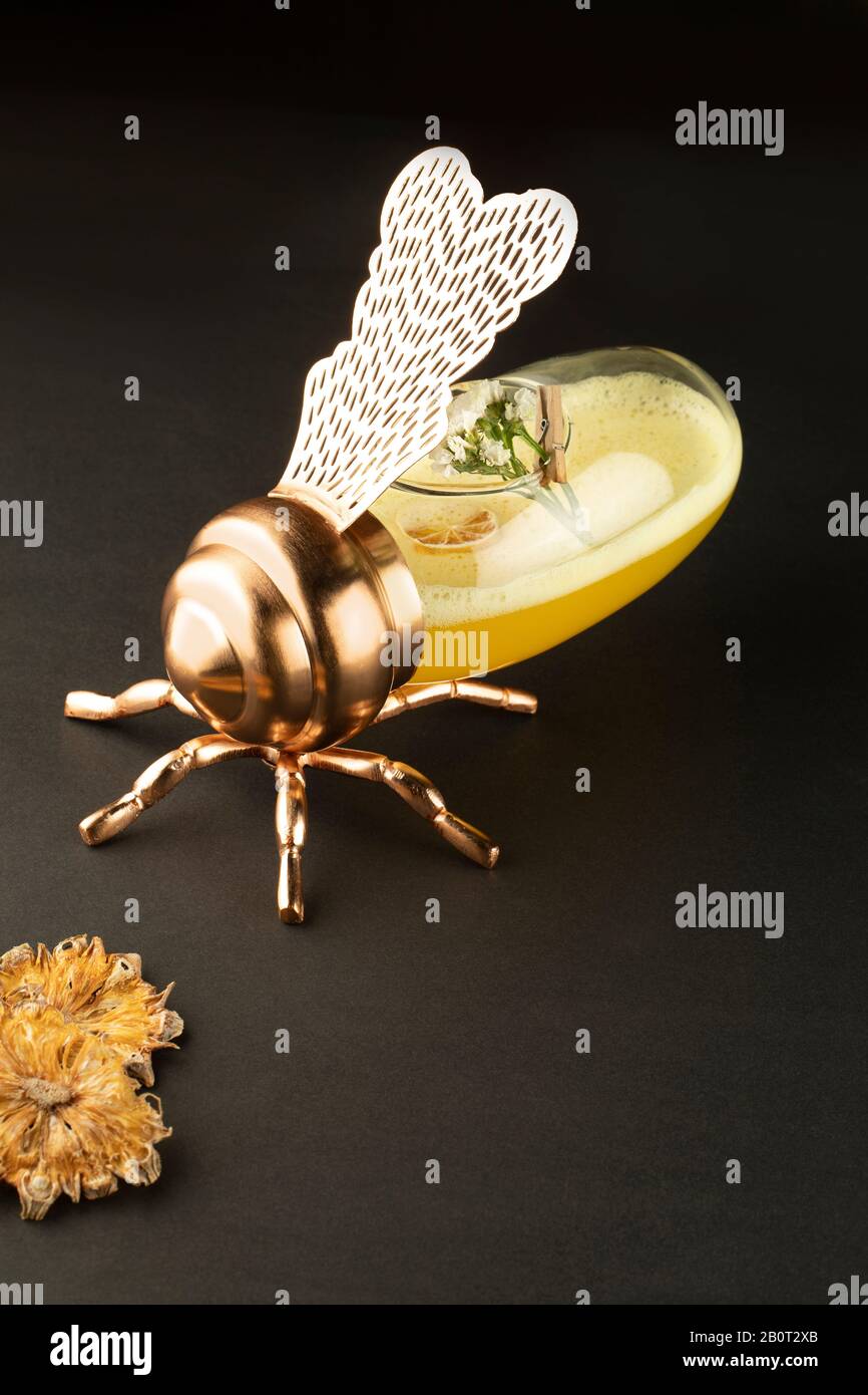 Artisan orange mocktail served in fancy bee container Stock Photo - Alamy