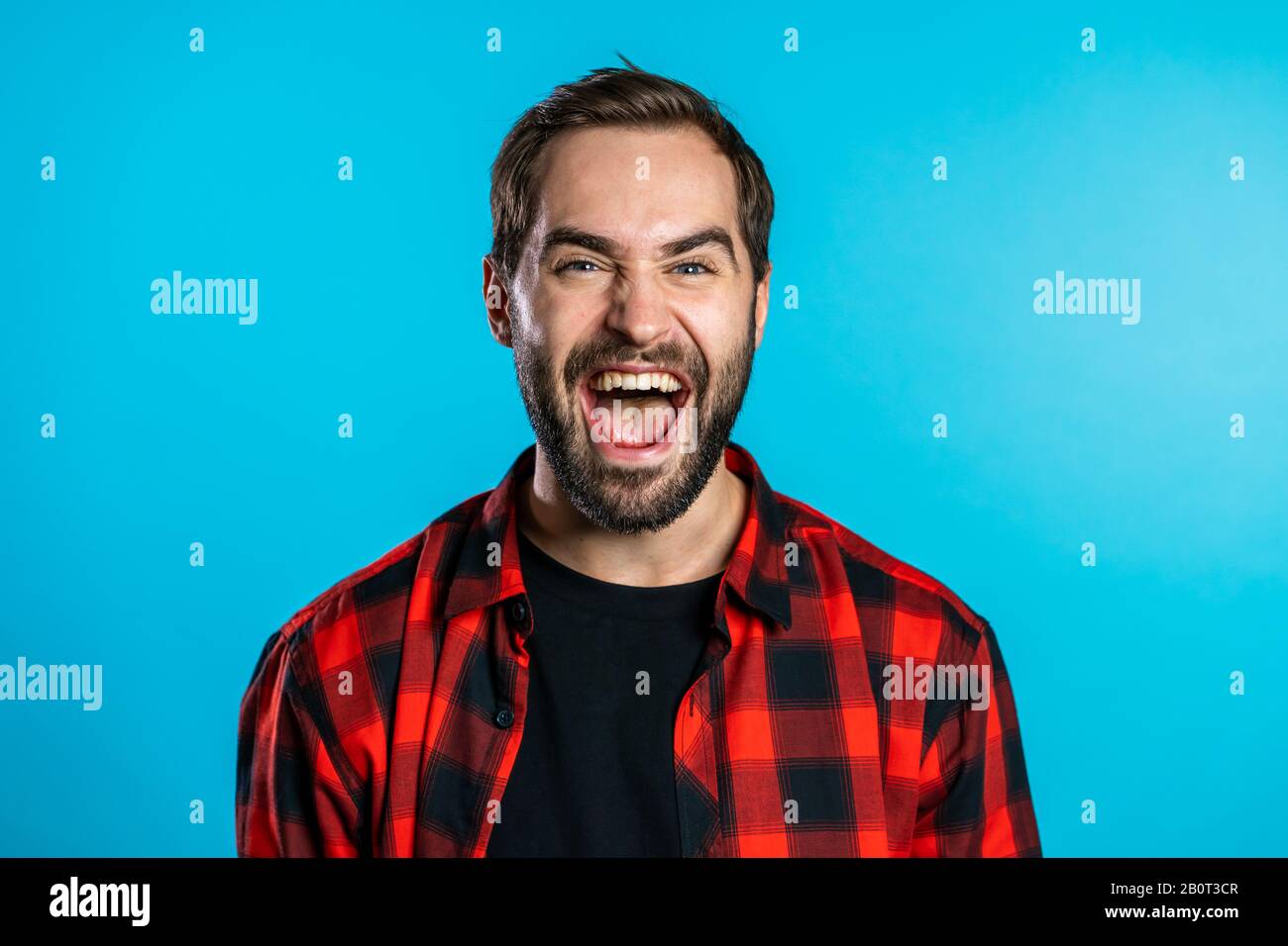 Man in red shirt very glad and happy, he smiling, screaming. Surprised ...