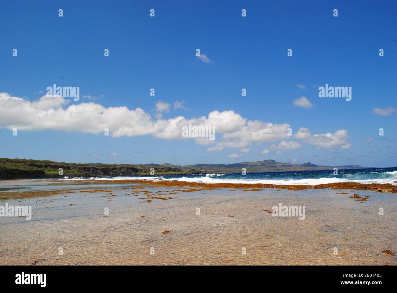 Wide shot of Tank Beach at low tide, Saipan, Northern Mariana Islands ...