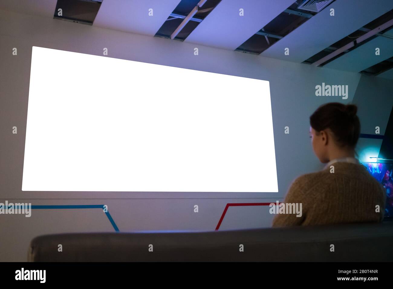 White screen concept - woman looking at large blank interactive white ...